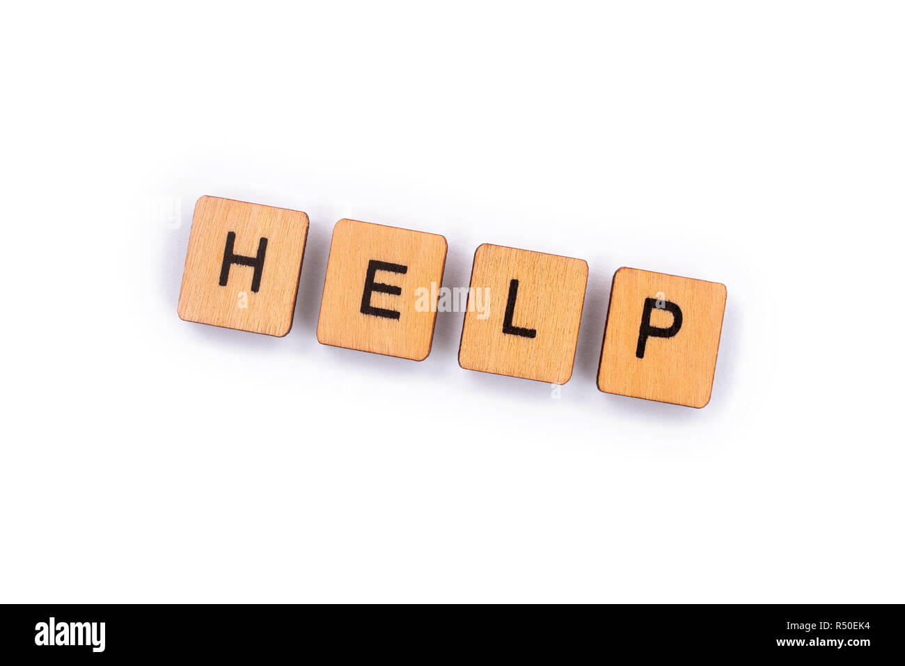 HELP, spelt with wooden letter tiles over a plain white background ...
