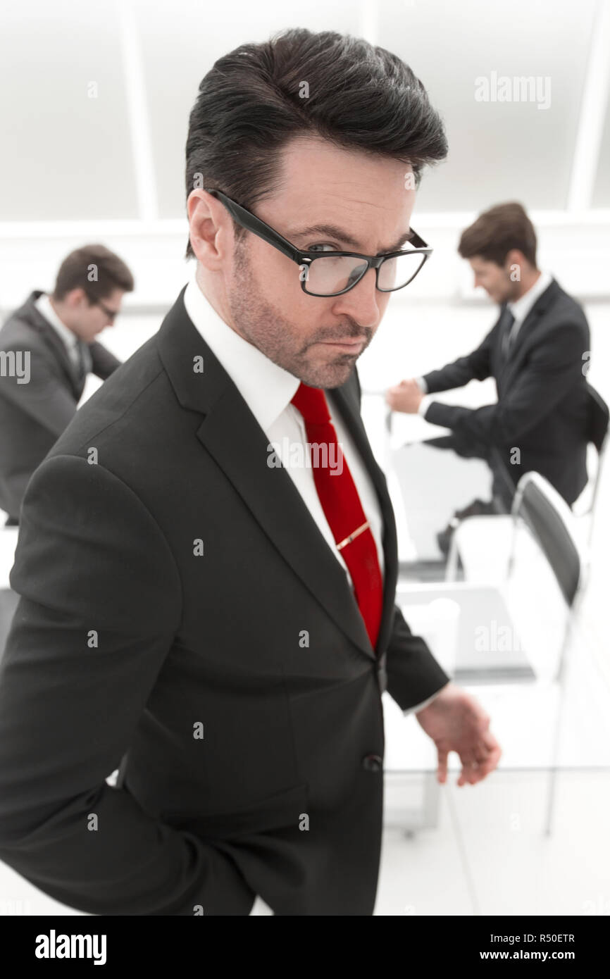 close up.serious boss standing in the conference room Stock Photo - Alamy