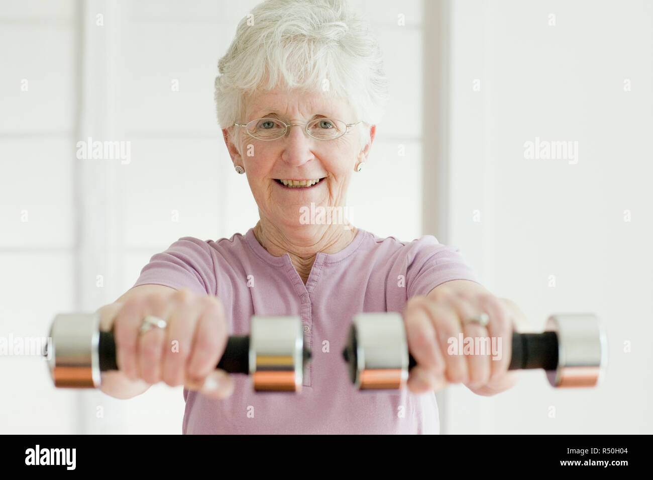 Old lady lifting weights hi-res stock photography and images - Alamy