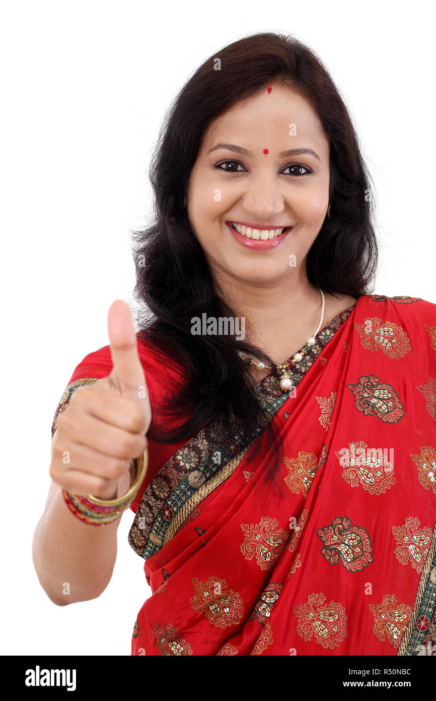 Cheerful traditional young Indian woman showing thumbs up gesture Stock ...