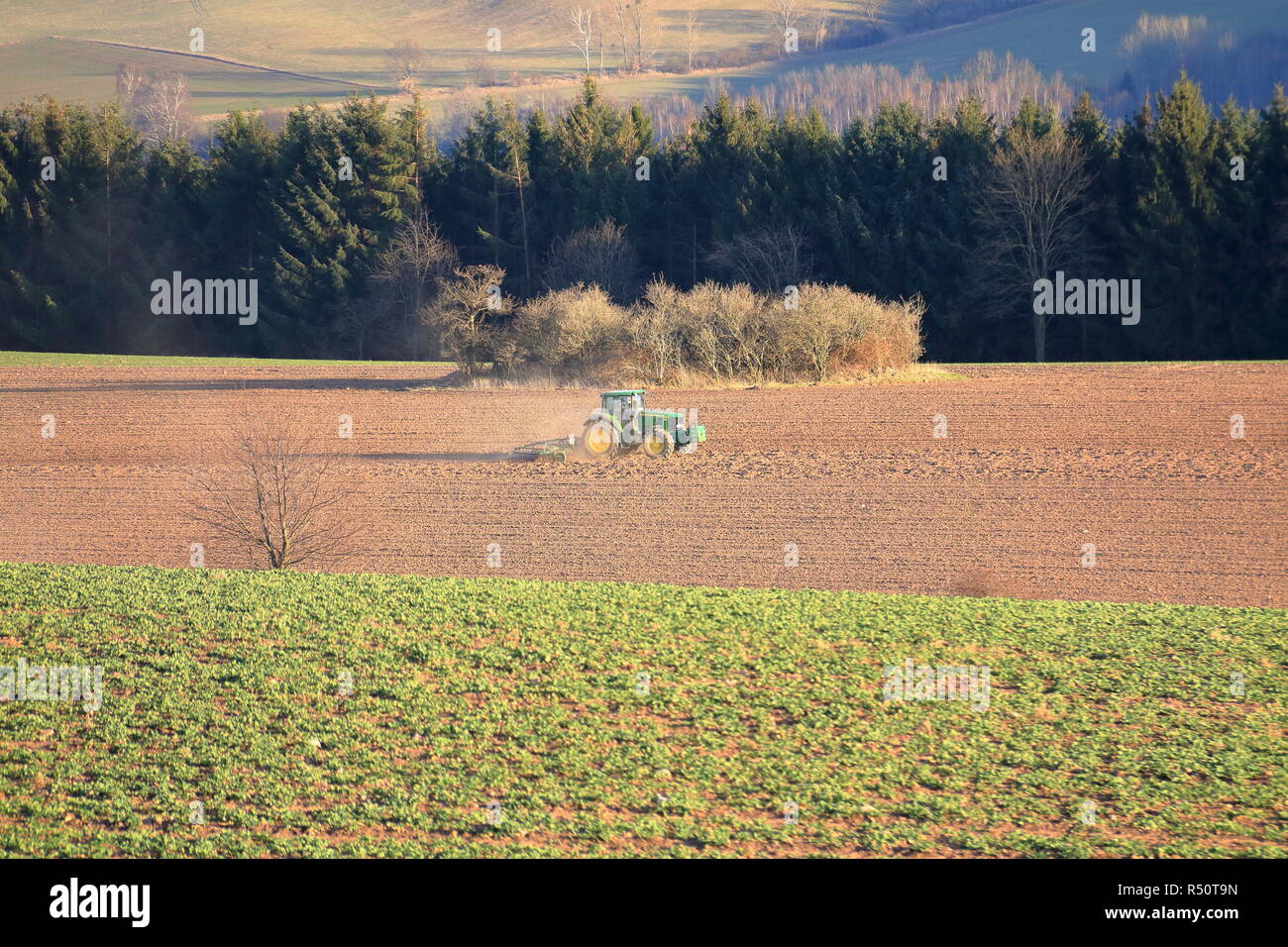 Tractor working on the farm, a modern agricultural transport, a farmer ...