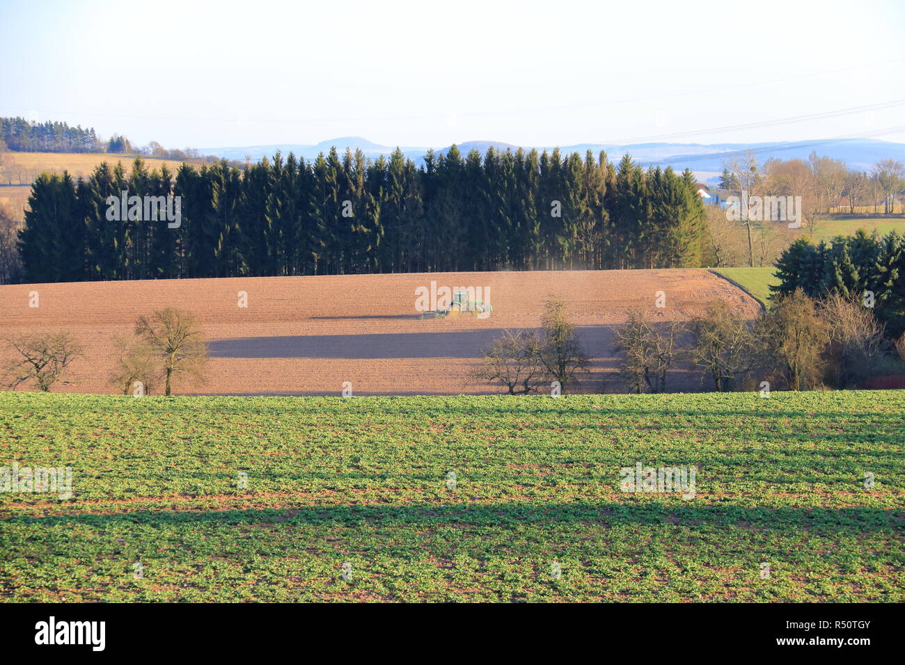 Tractor working on the farm, a modern agricultural transport, a farmer ...