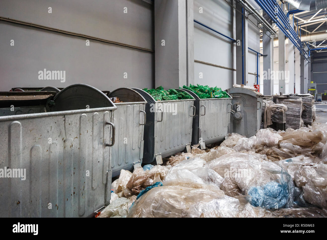 Containers with used bottles and plastic bales of rubbish at waste ...