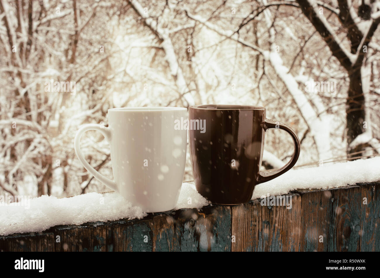 Cozy winter still life: Two Cups of Hot Coffee or Tea on a Snow Covered ...