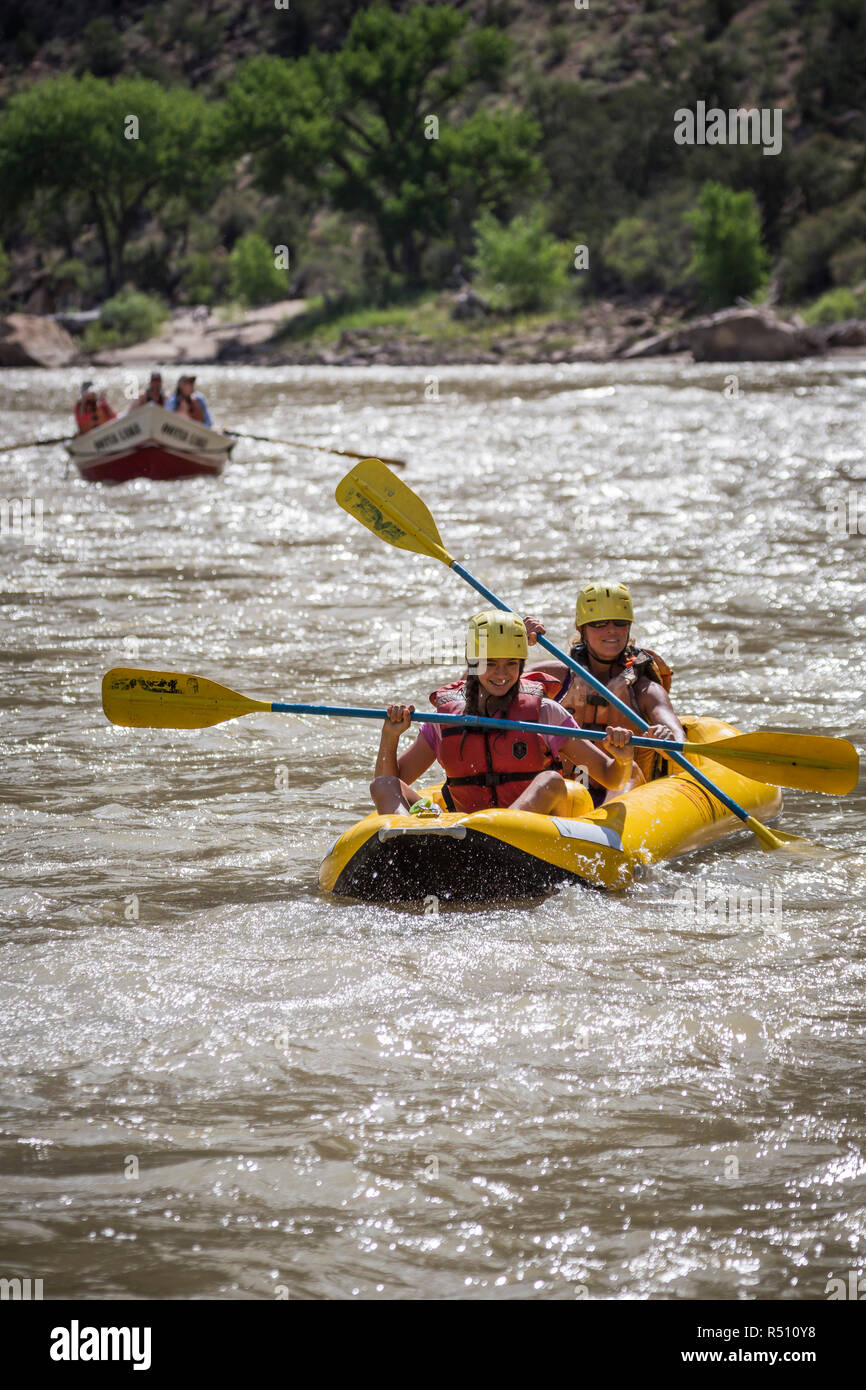 A young girl and her mother paddling an inflatable kayak, Green river ...