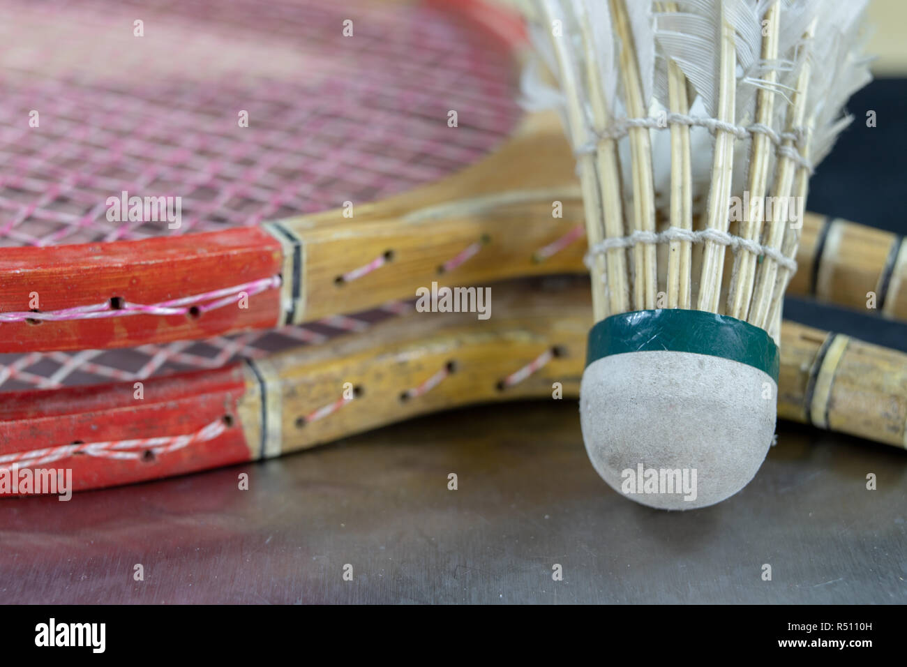 Old badminton accessories on a light table. Set for outdoor games and ...