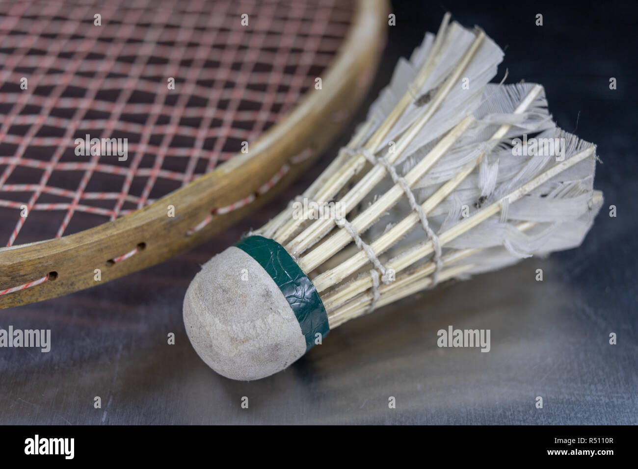 Old badminton accessories on a light table. Set for outdoor games and ...