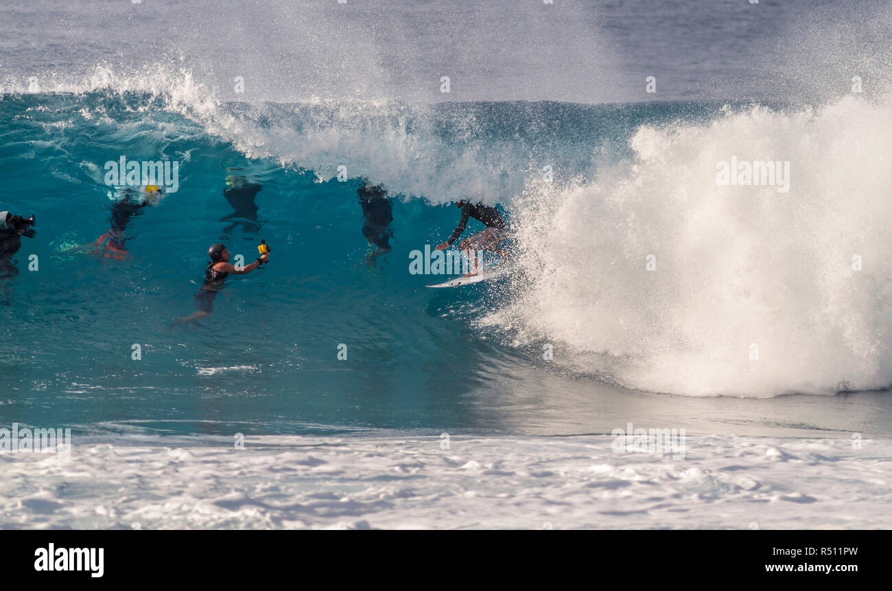 Surf photographers shooting a surfer in a wave Stock Photo - Alamy