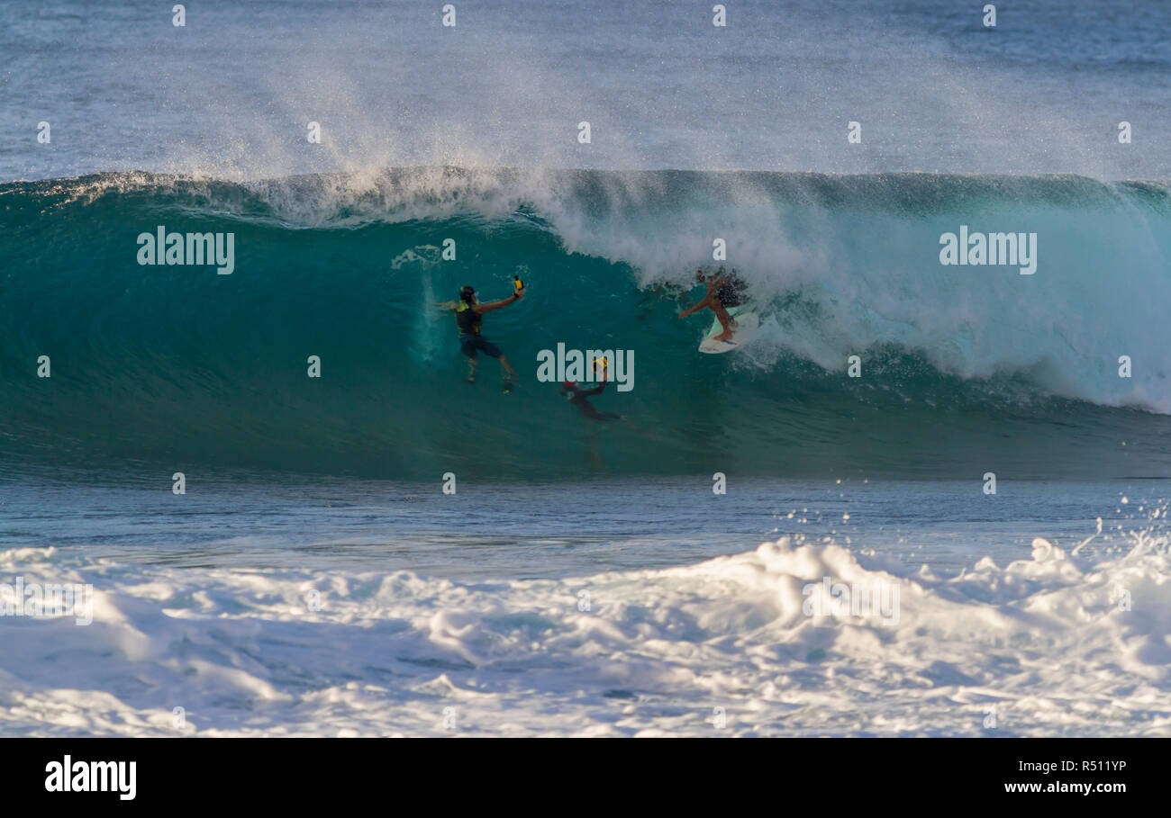 Surf photographers shooting a surfer in a wave Stock Photo - Alamy
