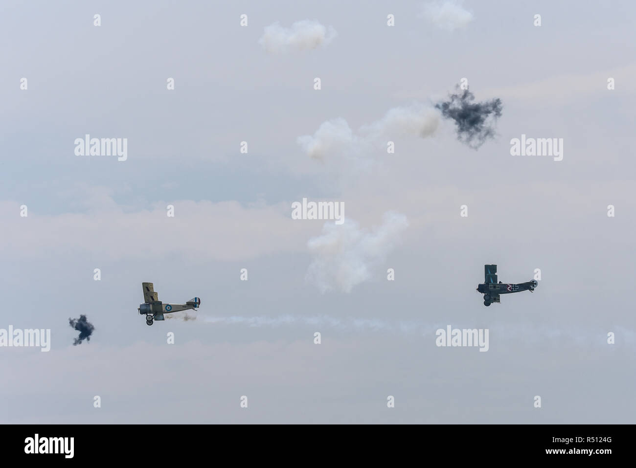 Great War Display Team flying at an airshow with explosion pyrotechnics ...