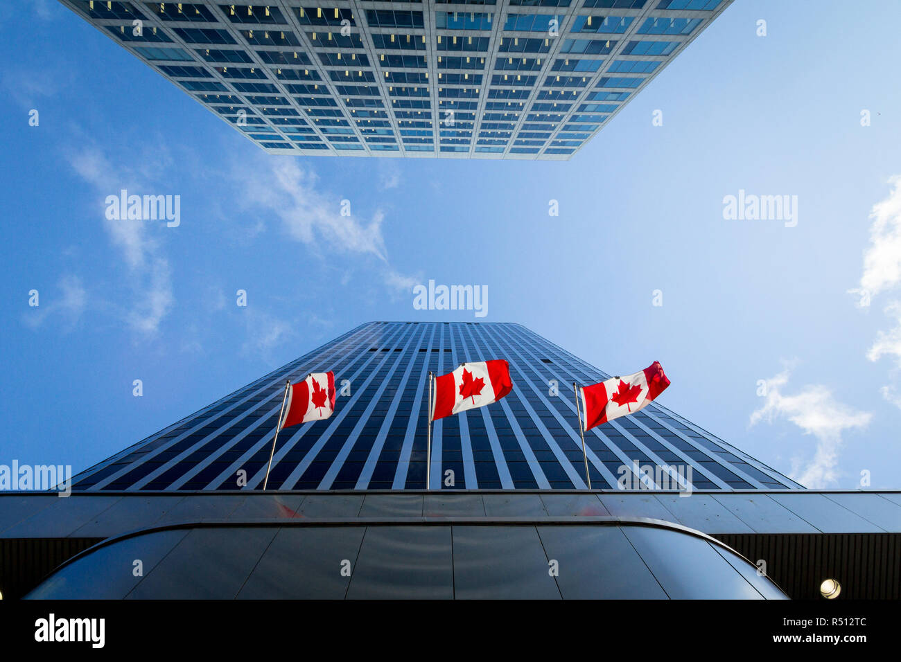 Three Canadian flags in front of a business building in Ottawa, Ontario, Canada. Ottawa is the ...