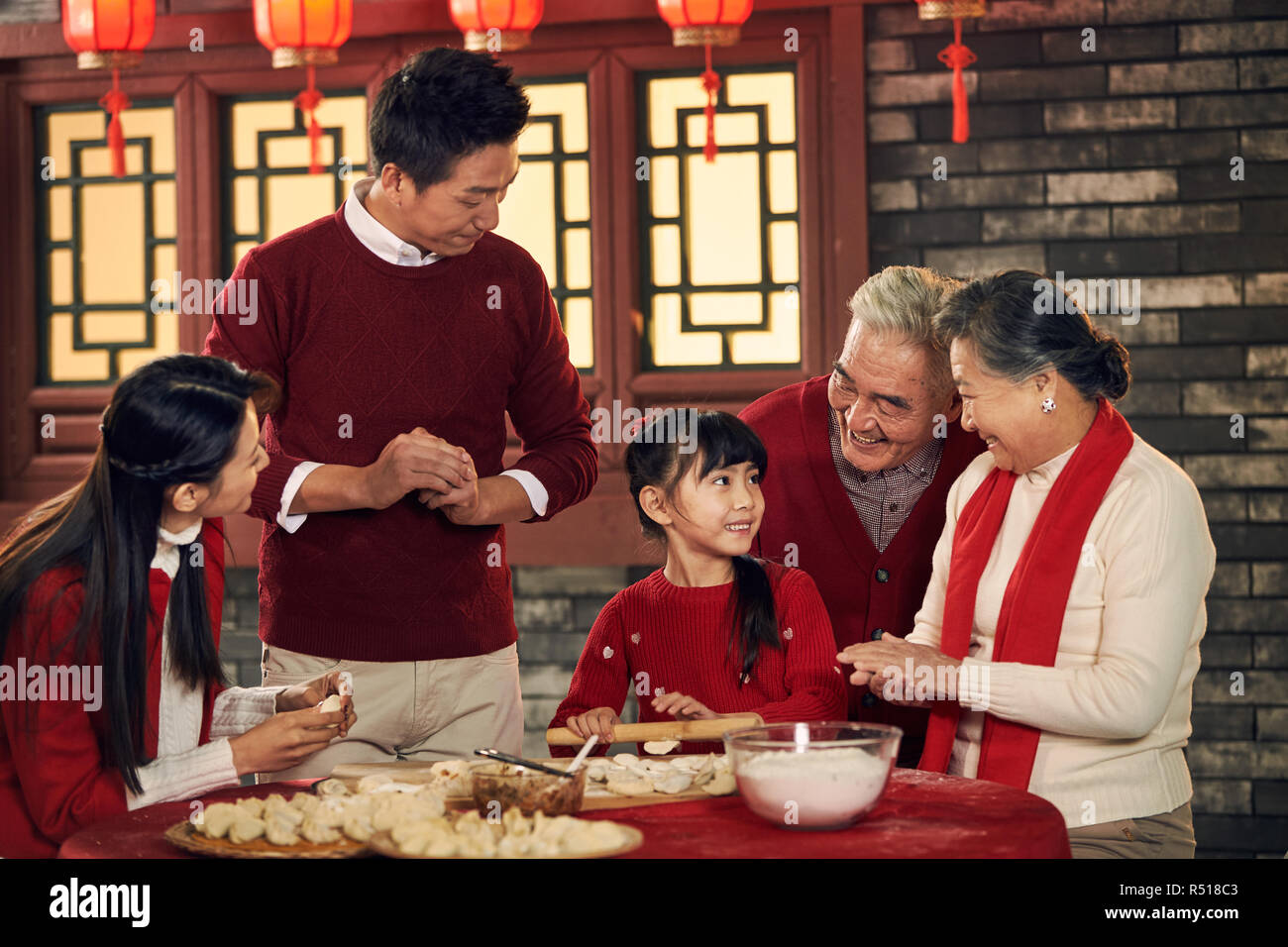 Happy Chinese New Year pack dumpling family Stock Photo - Alamy