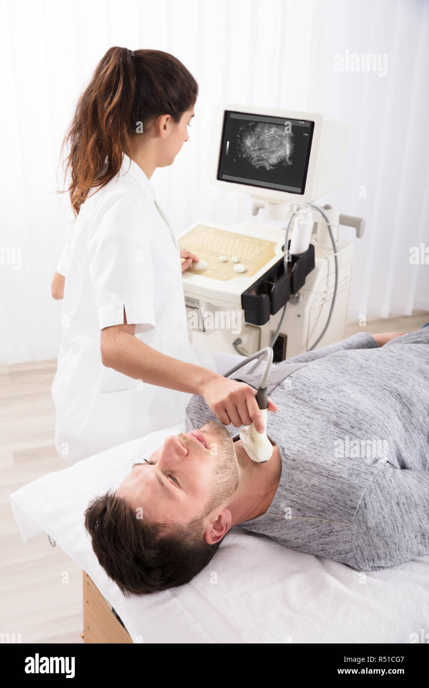 Man Getting Ultrasound Of A Thyroid From Doctor Stock Photo - Alamy