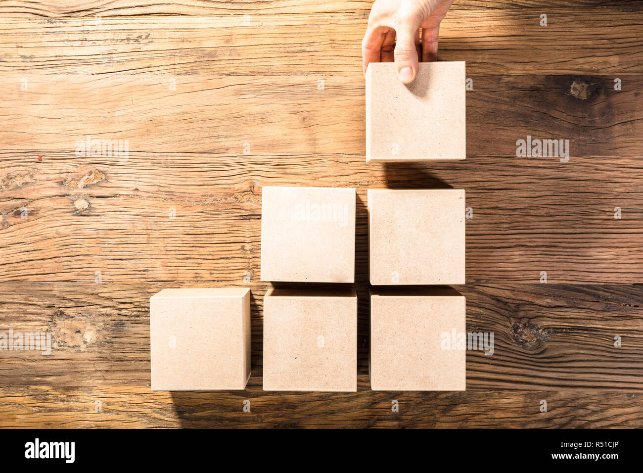 Person's Hand Arranging Wooden Block Stock Photo - Alamy