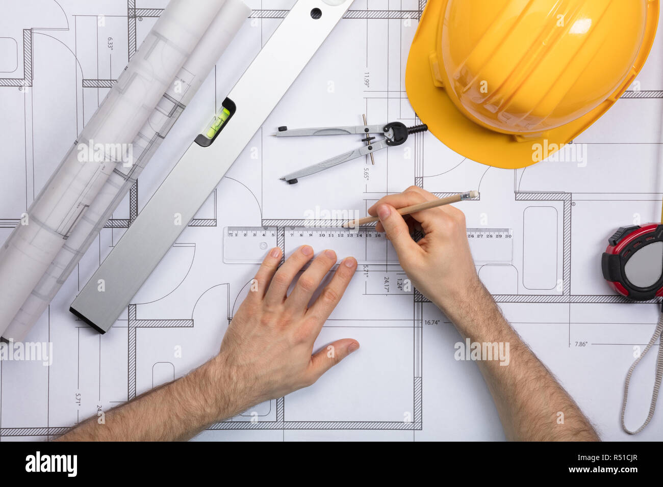 Architect hands working on blueprint Stock Photo - Alamy