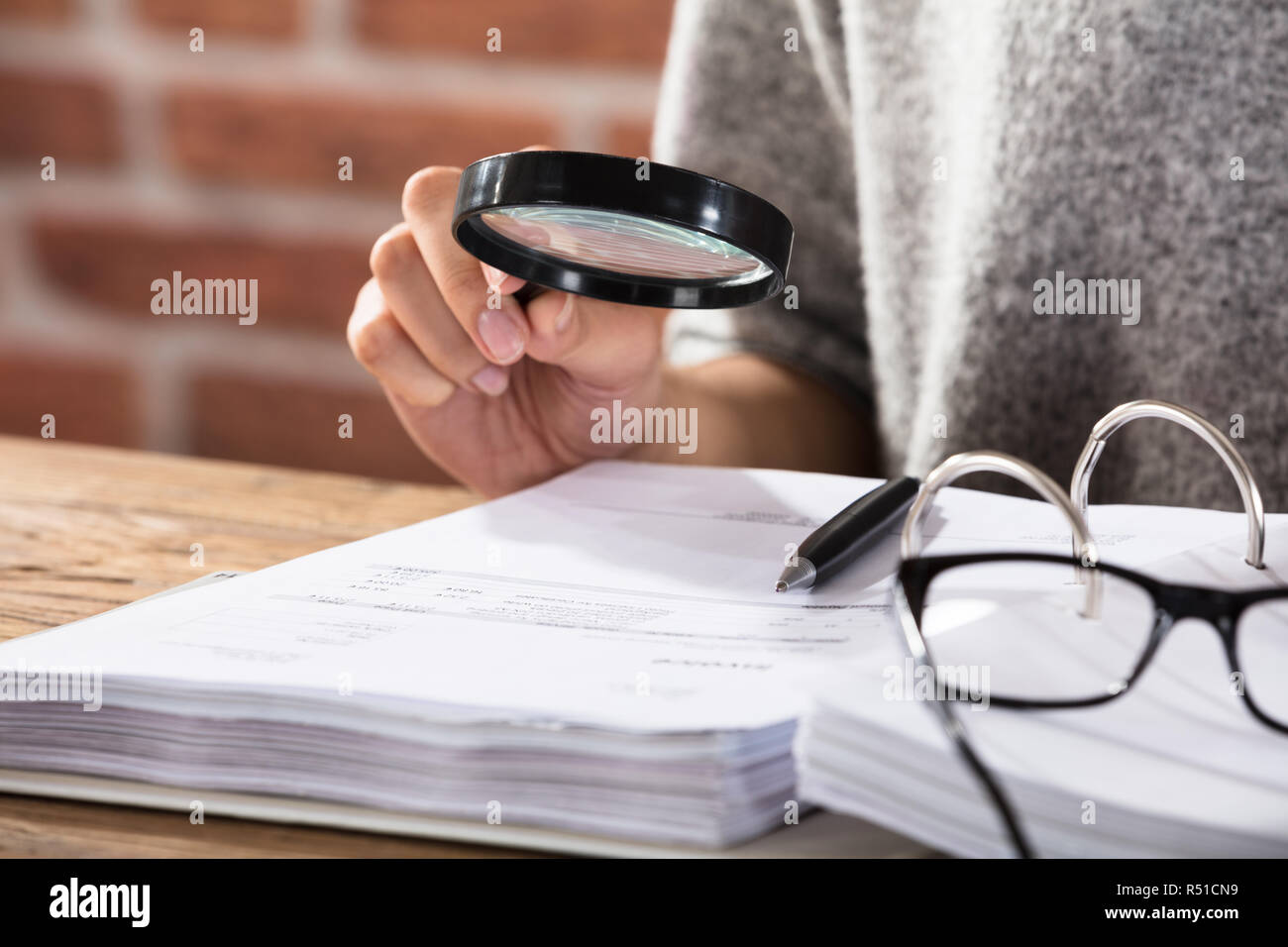 Businesswoman Looking At Document Through Magnifying Glass Stock Photo ...
