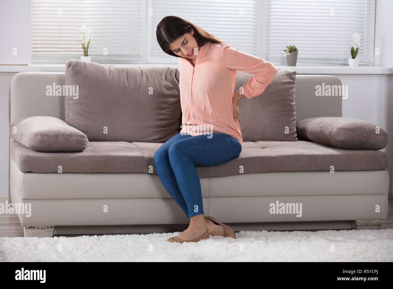 Young Woman Having Back Pain Stock Photo - Alamy