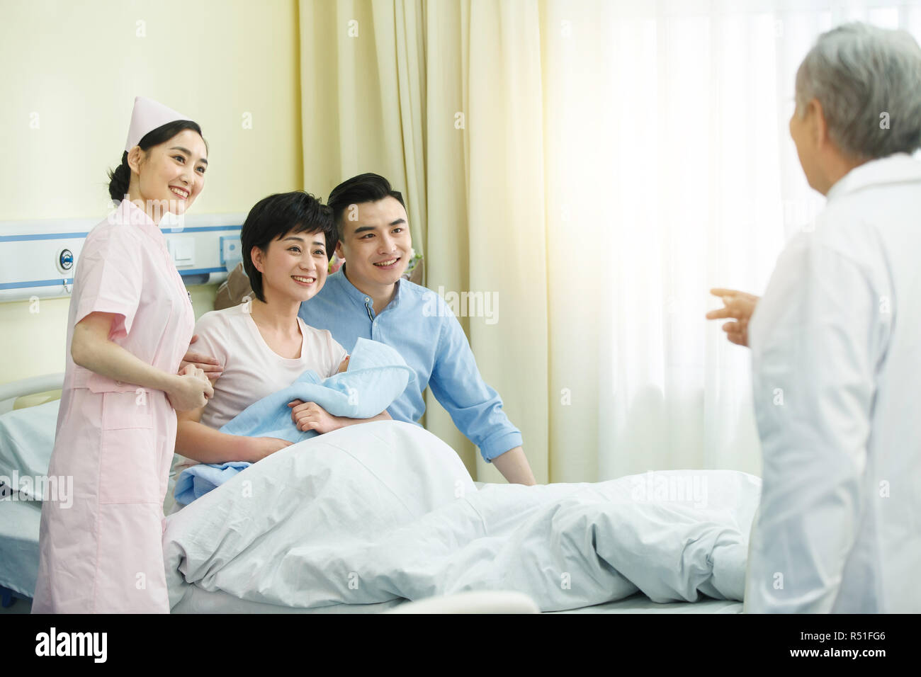 Medical staff and the parents of the newborn Stock Photo - Alamy