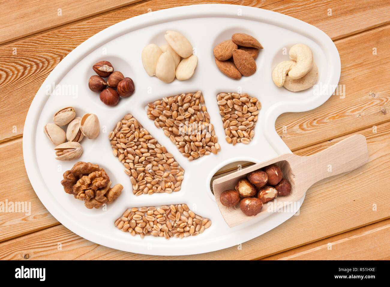 artist pallets with nuts and grains on wood slanting Stock Photo - Alamy