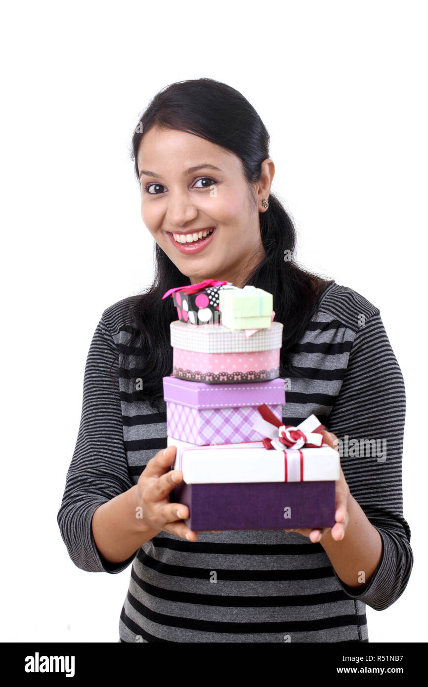 Young woman holding boxes against white Stock Photo - Alamy