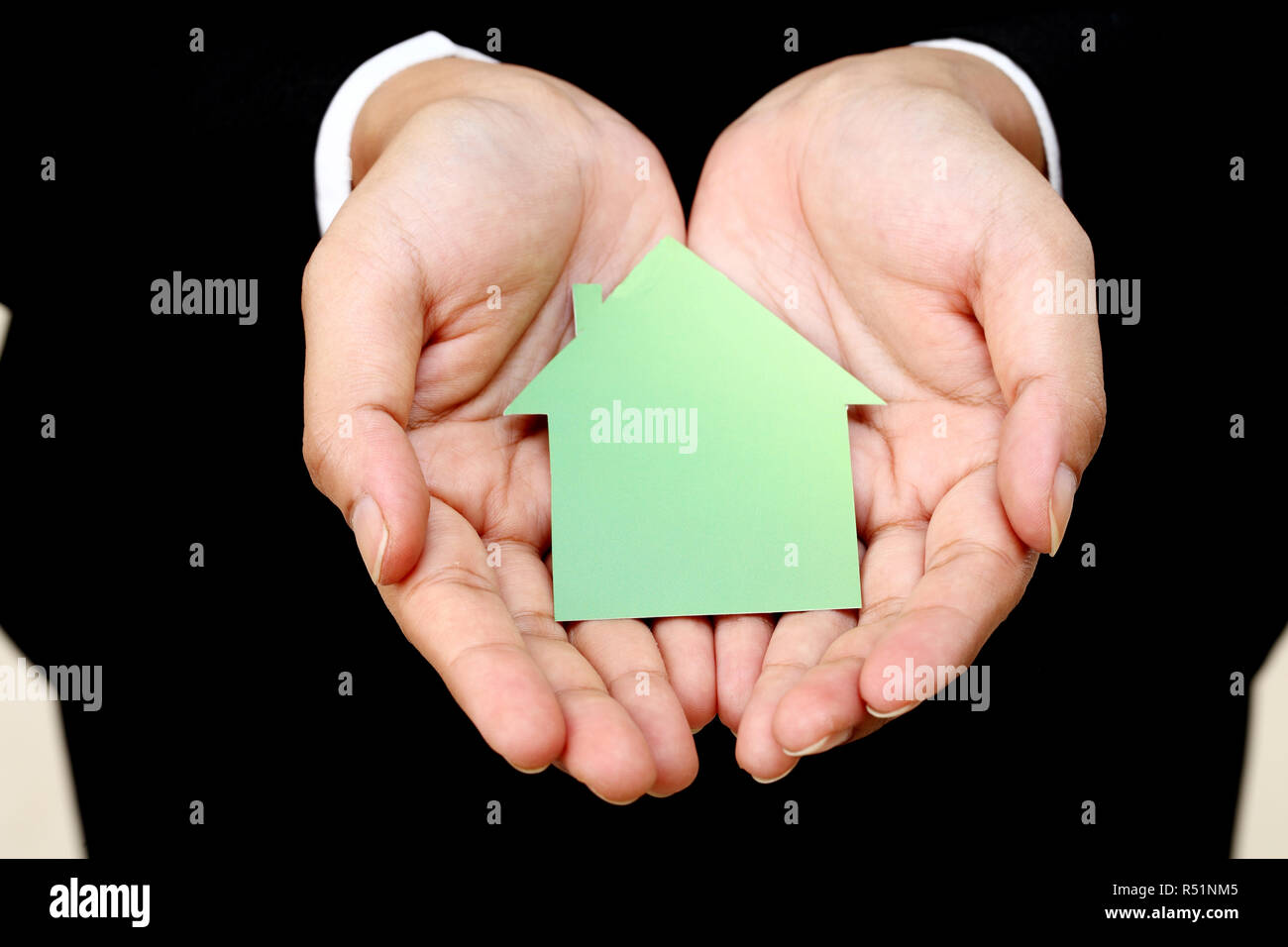 House shape in business woman's hands Stock Photo - Alamy