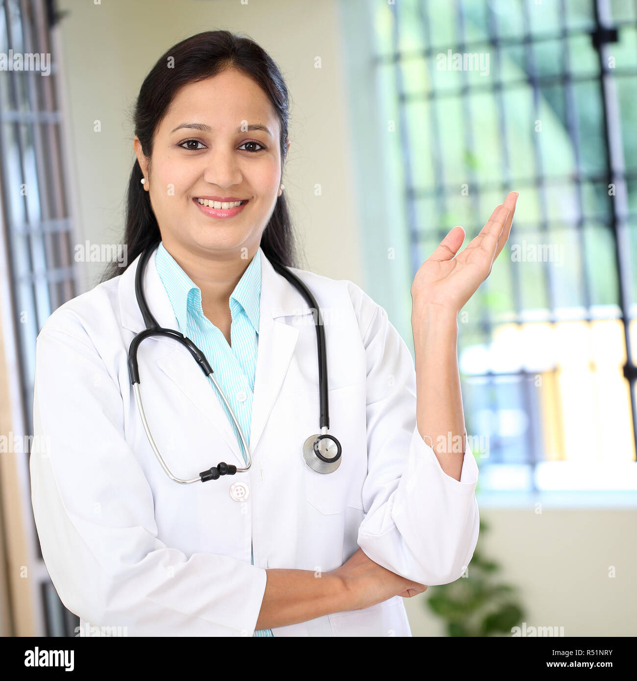 Young female doctor presenting copy space for product Stock Photo - Alamy