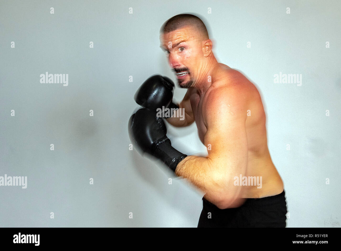 male boxer european while training in action and throwing punch Stock ...