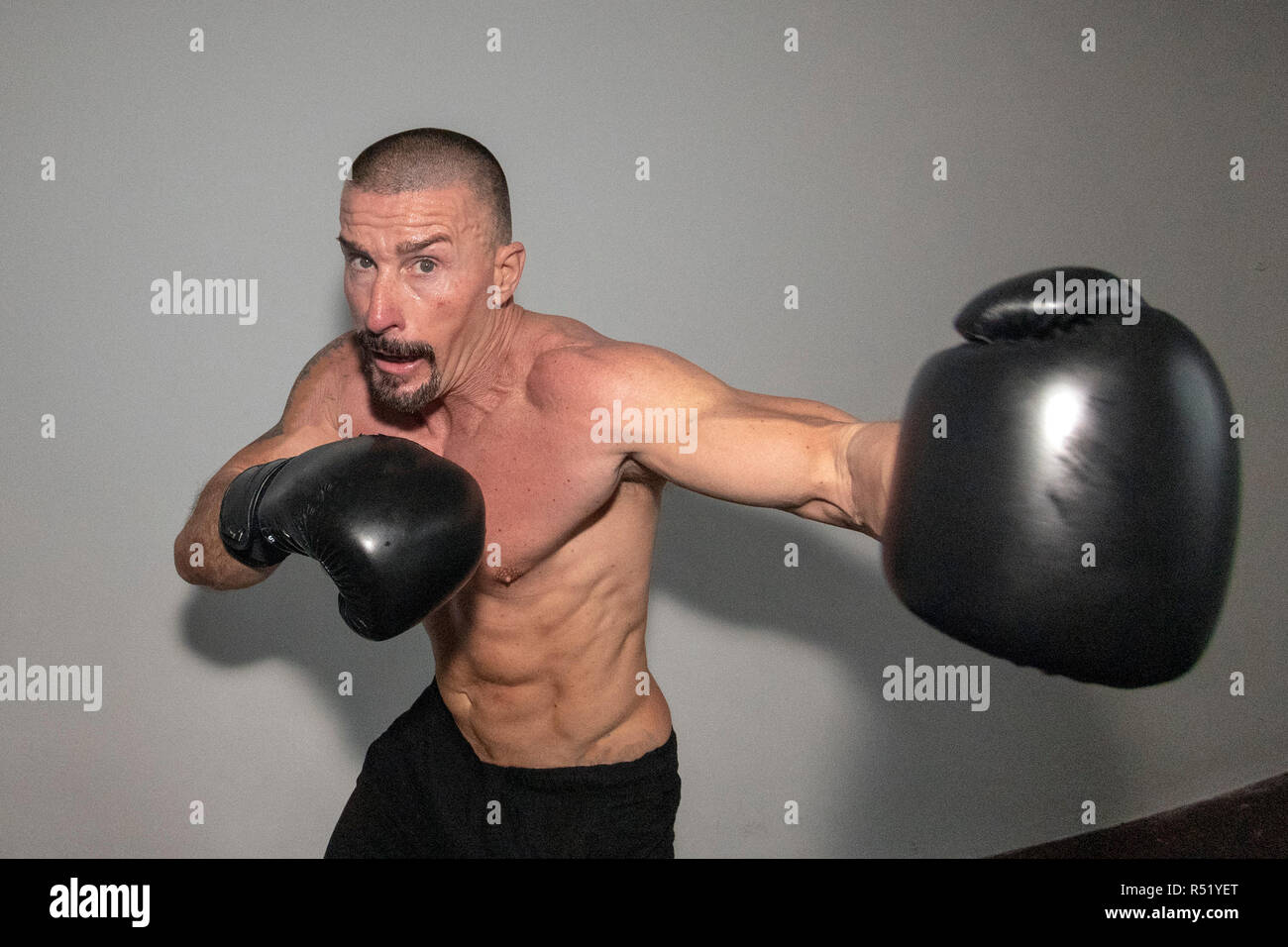 male boxer european while training in action and throwing punch Stock ...