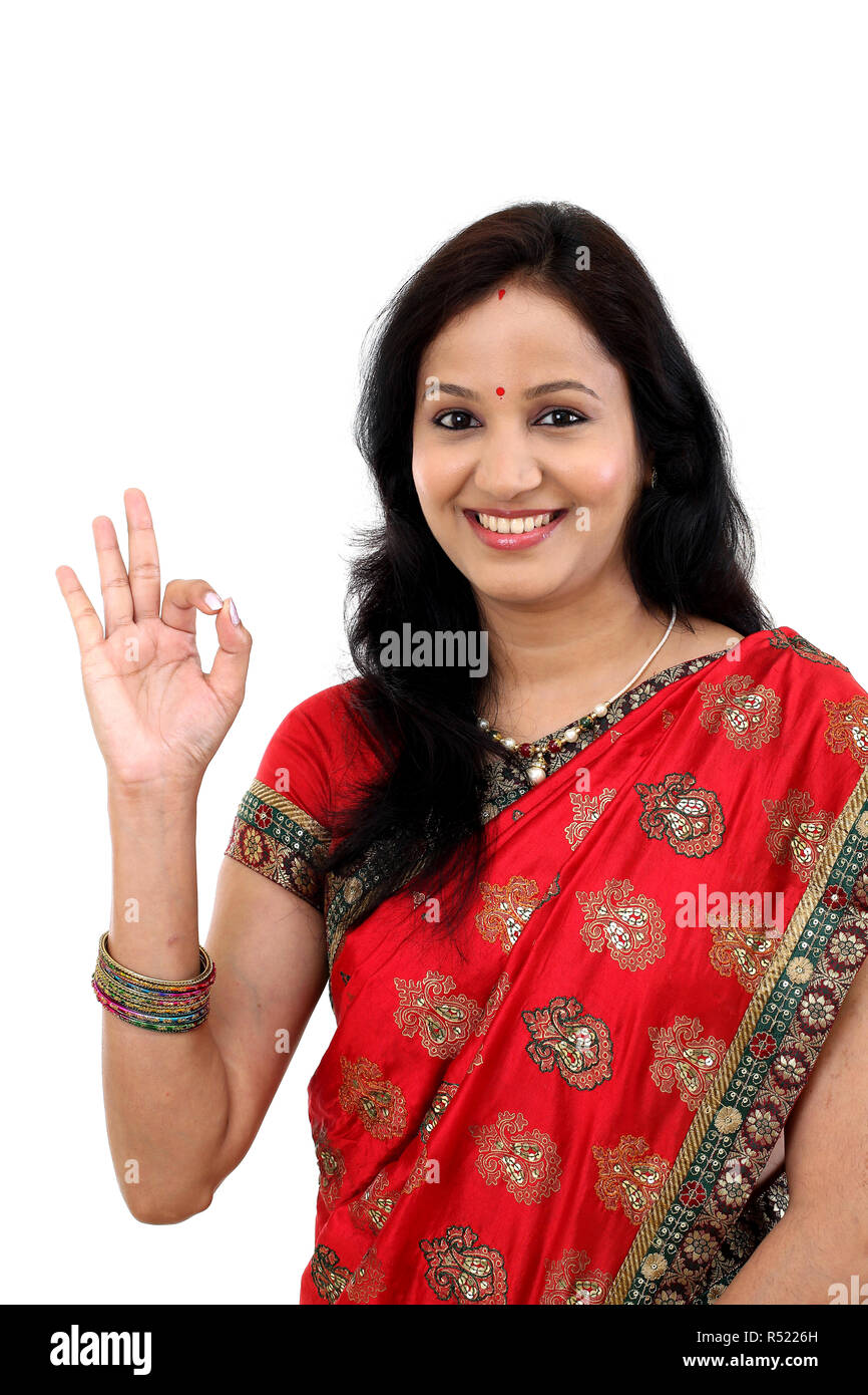 Traditional Indian Young woman making OK sign Stock Photo - Alamy