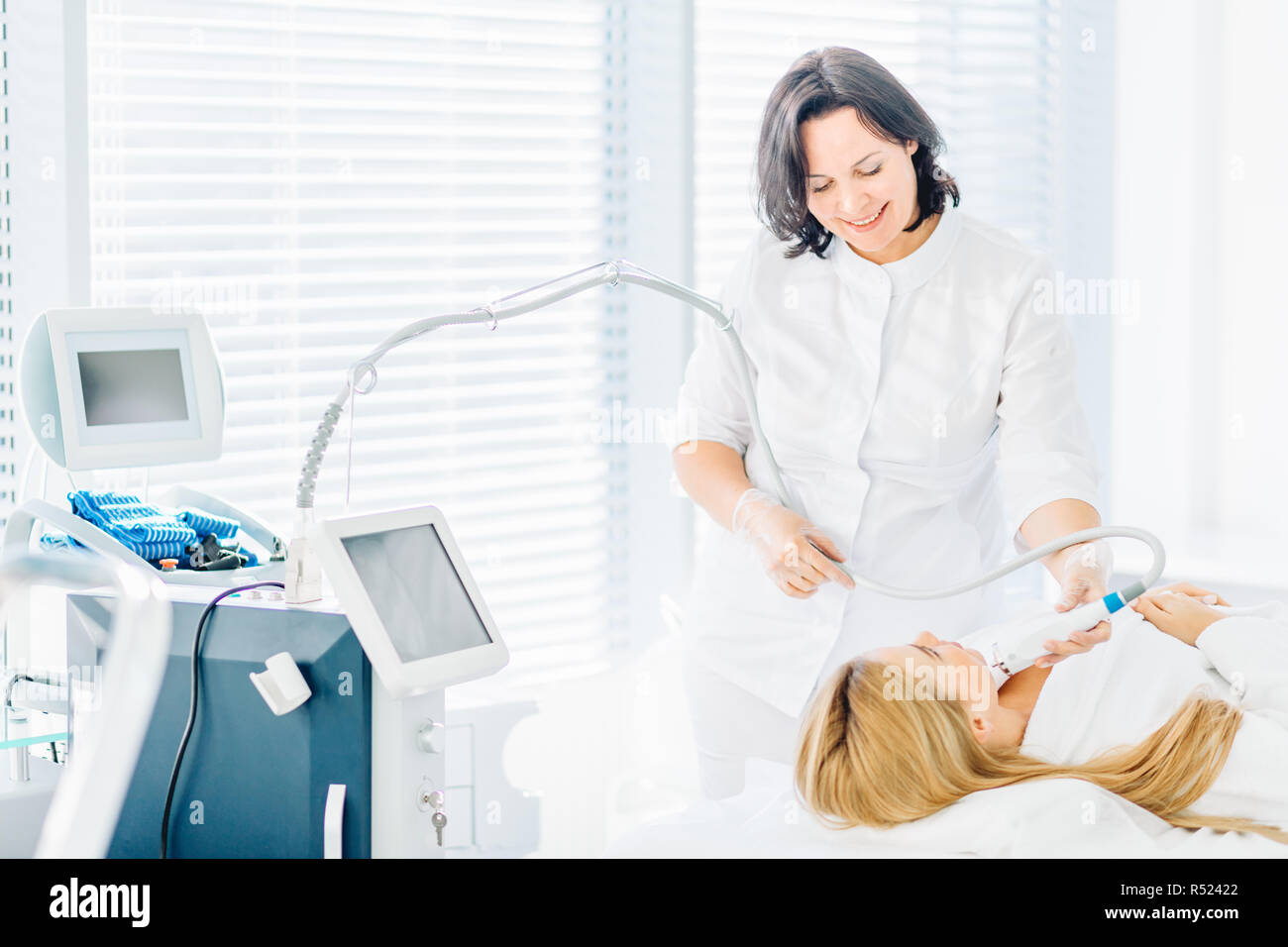Face skin care. Woman getting facial laser treatment Stock Photo - Alamy