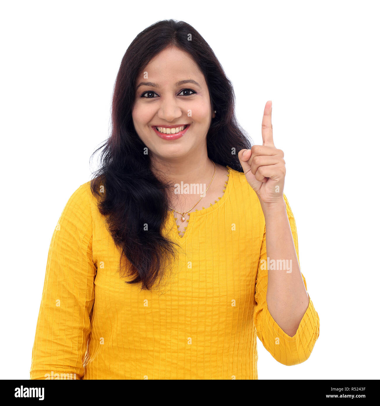Young woman showing index finger against white background Stock Photo ...
