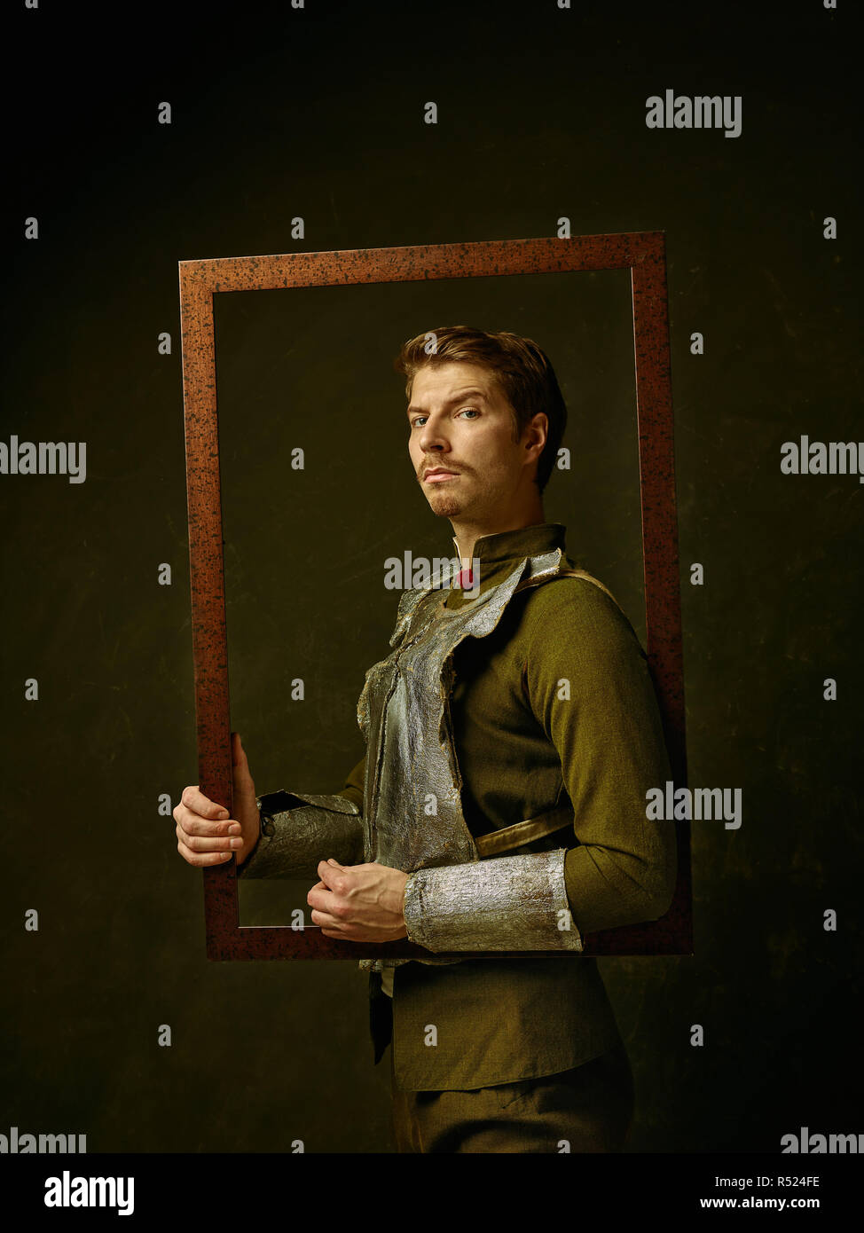 Medieval knight on dark studio background. Portrait in low key of ...