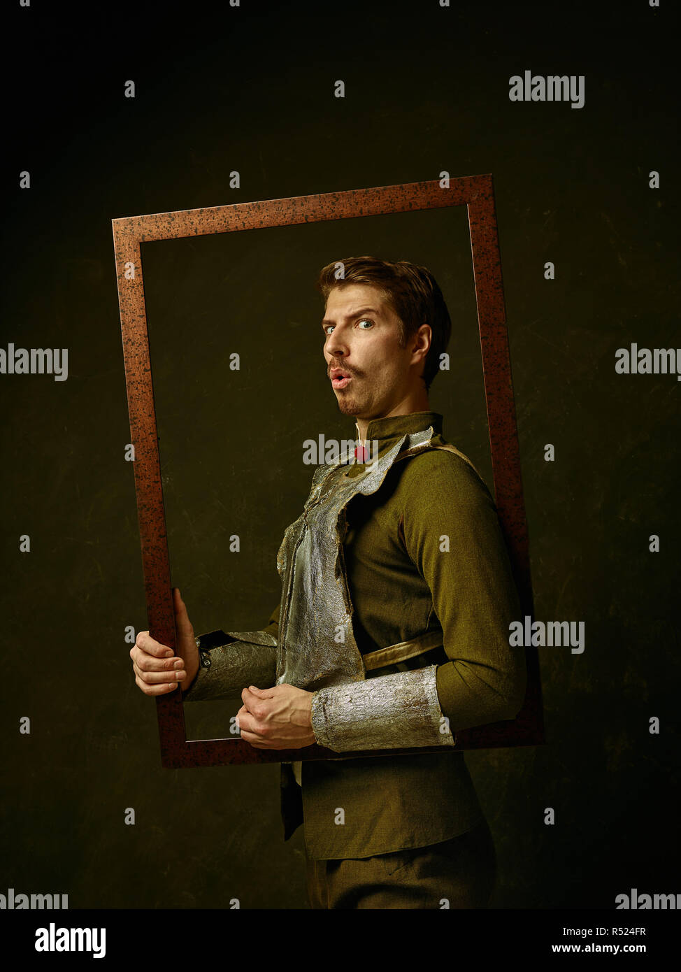 Medieval knight on dark studio background. Portrait in low key of ...