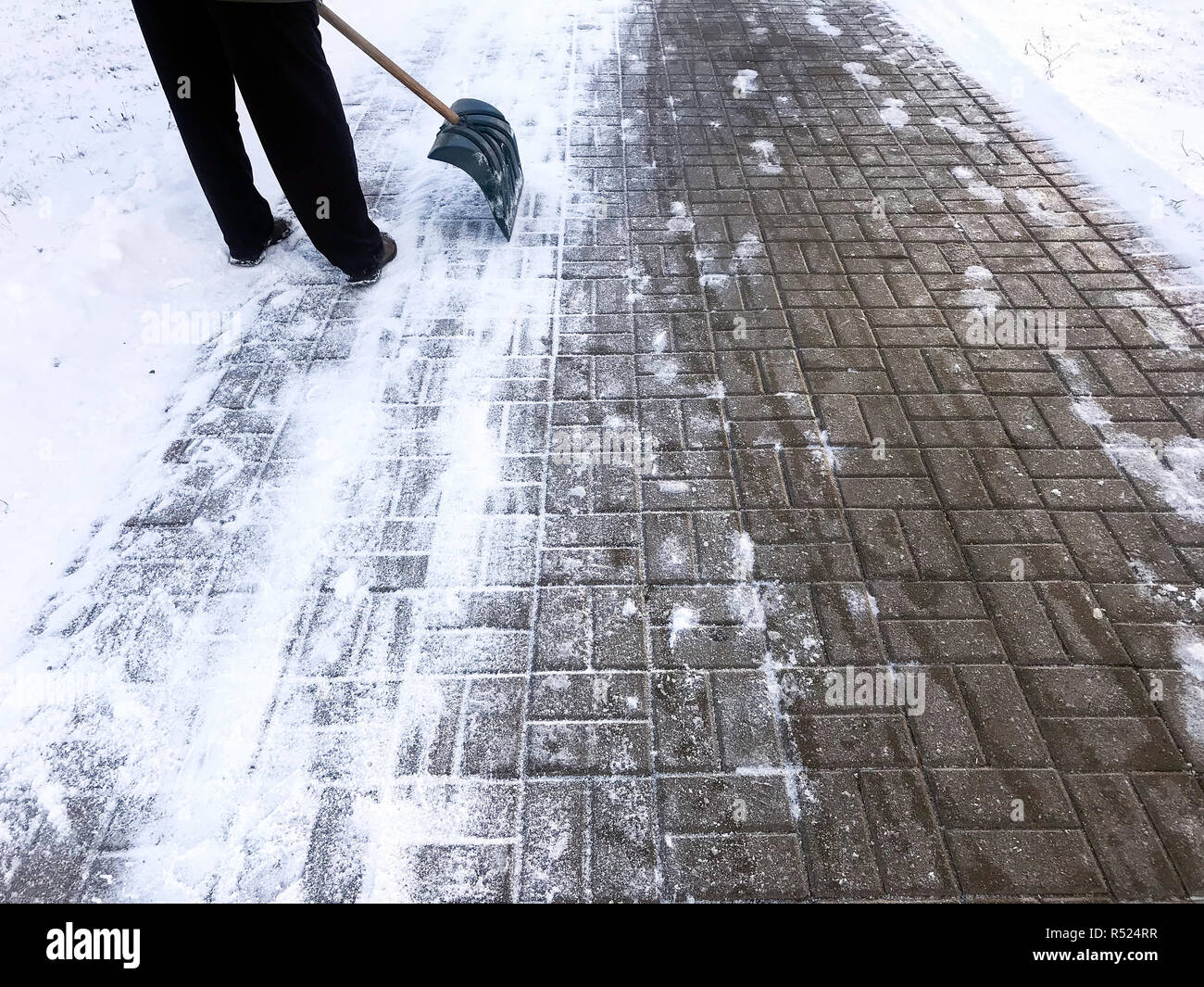 Person clearing path in snow hi-res stock photography and images - Alamy