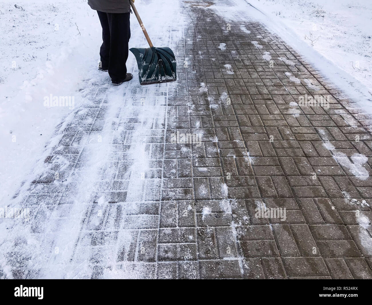 Worker sweep snow from road in winter Stock Photo - Alamy