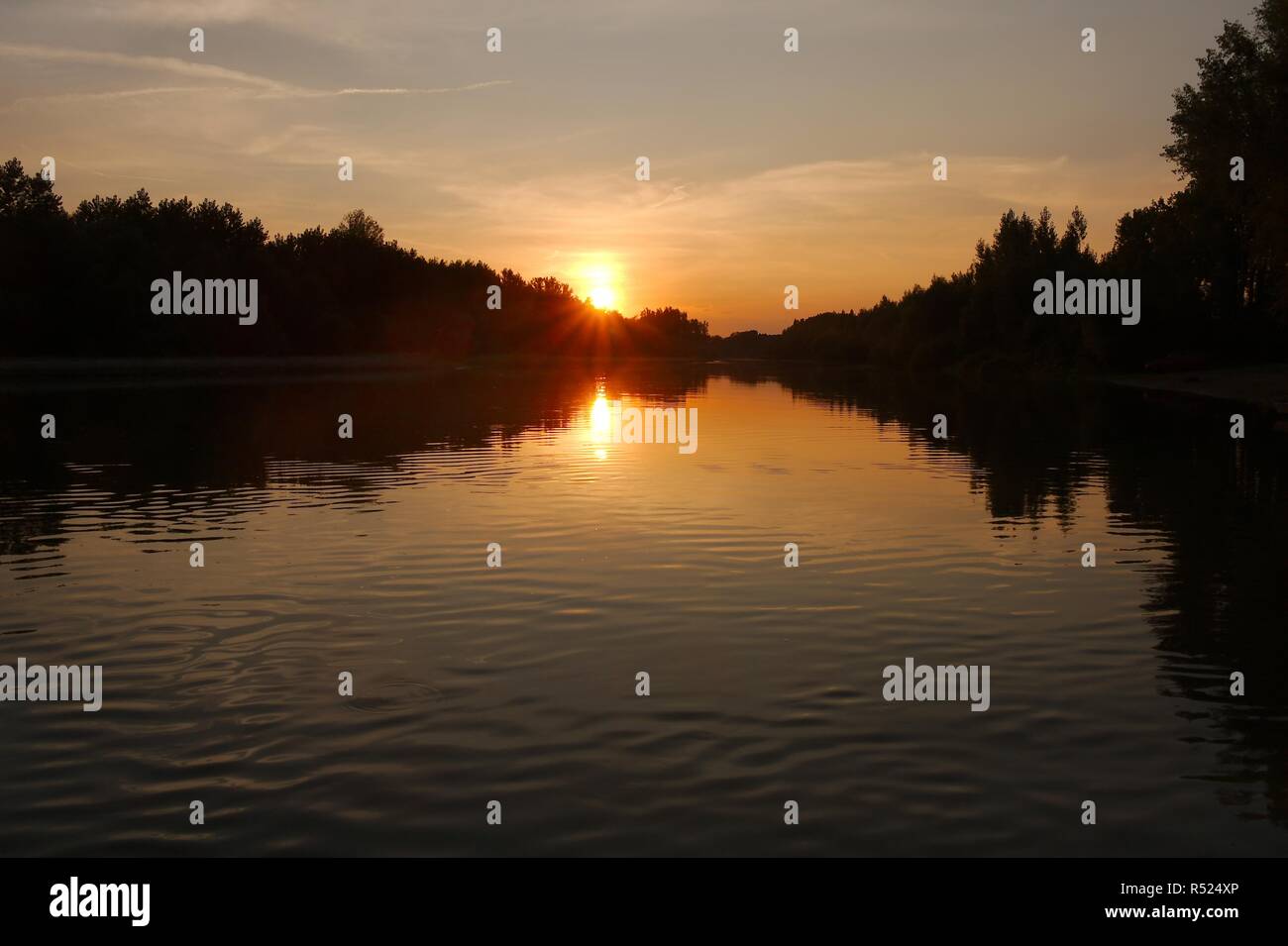 Sunset over a river Stock Photo - Alamy