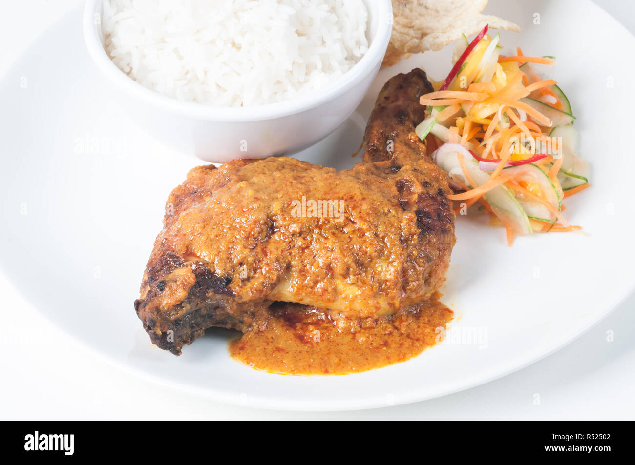 Classic Chicken Rendang with rice and vegetable pickles Stock Photo - Alamy