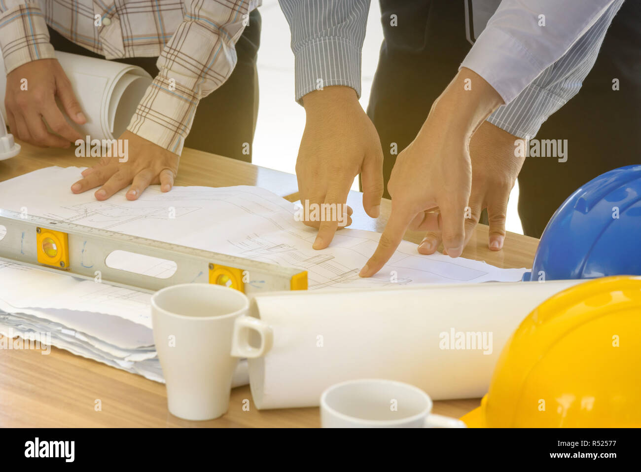 Business teamwork working on blueprint Stock Photo - Alamy