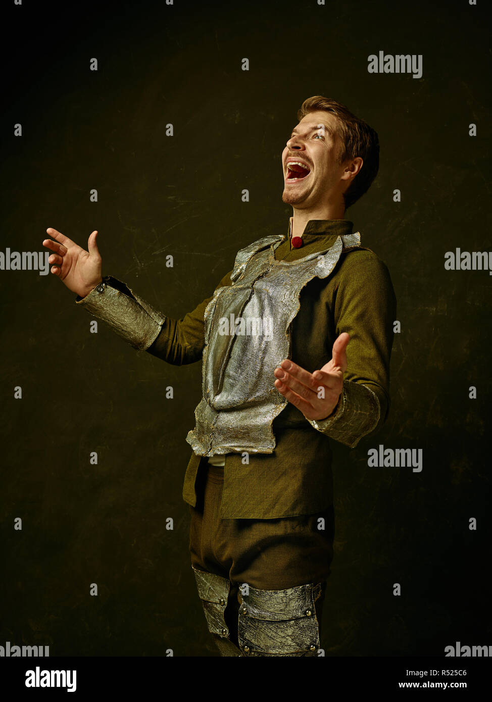 Medieval happy knight on dark studio background. Portrait in low key of ...