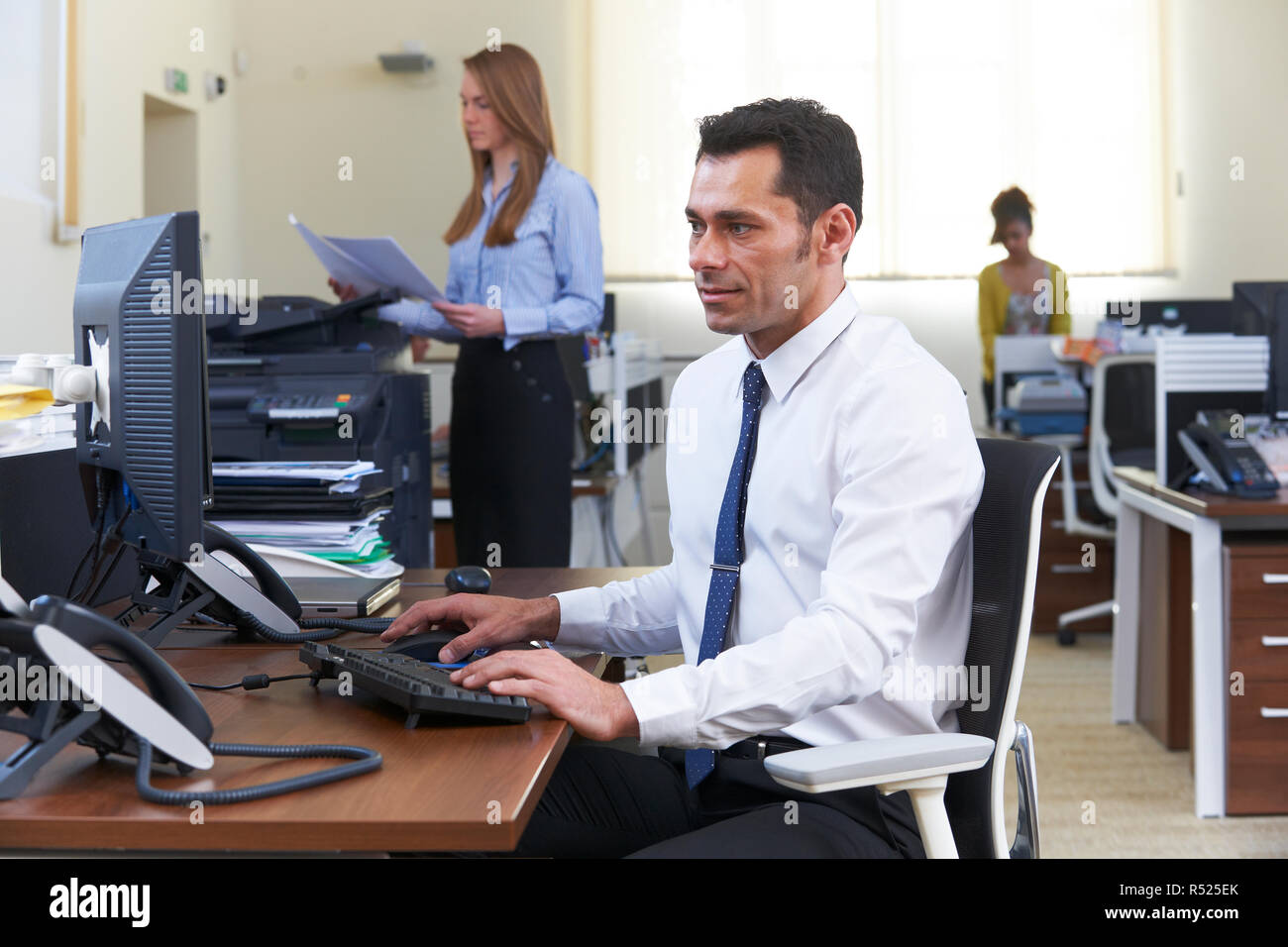 Male businessman working on computer hi-res stock photography and ...