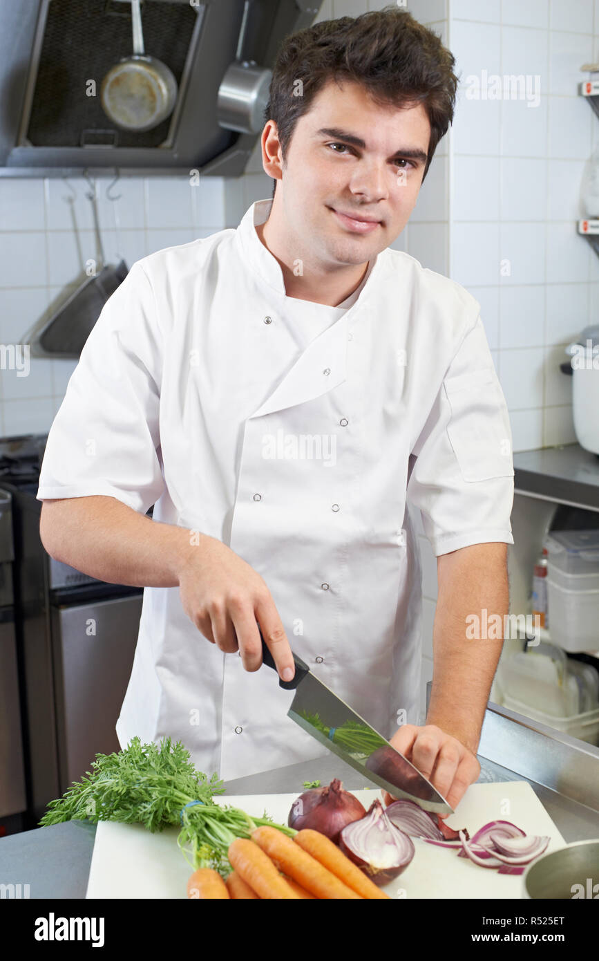 Portrait Of Chef Preparing Vegetables In Restaurant Kitchen Stock Photo ...