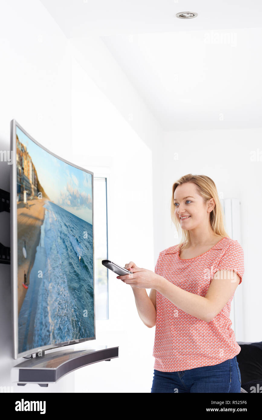 Young Woman With New Curved Screen Television At Home Stock Photo - Alamy