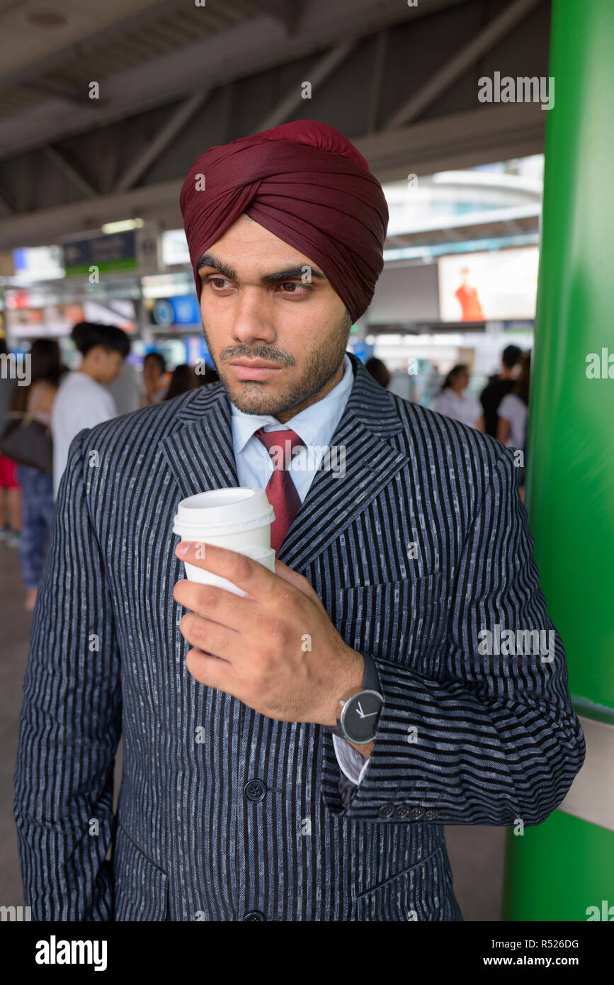 Young handsome Indian Sikh businessman wearing turban while expl Stock ...