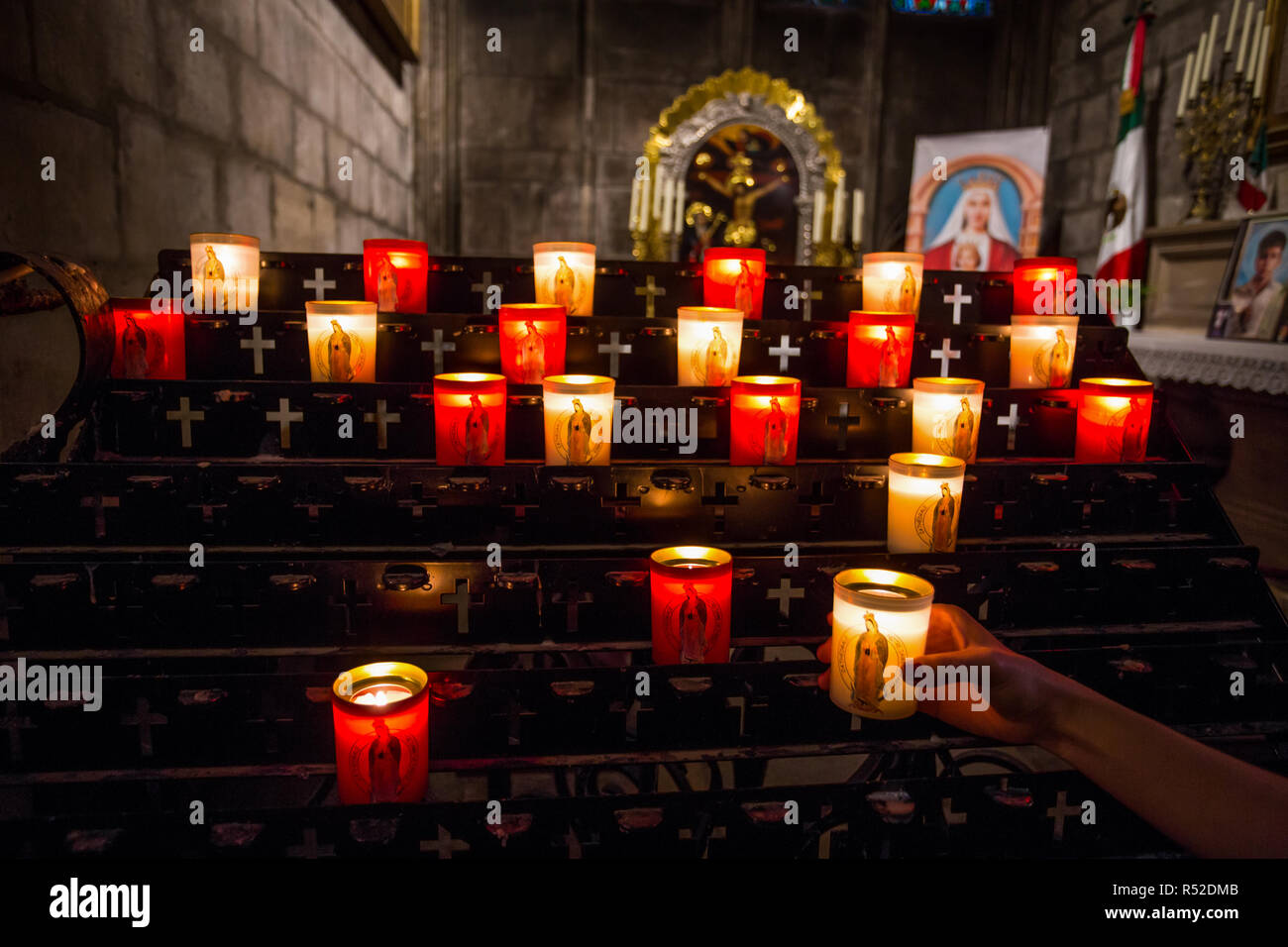 Hand lighting a candle in the church Stock Photo - Alamy