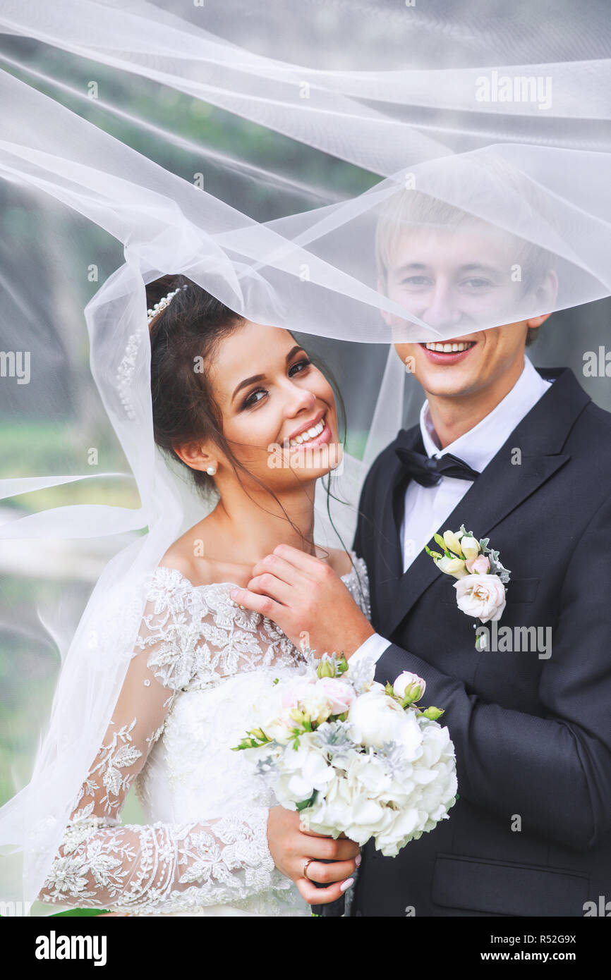 Young wedding couple under veil hi-res stock photography and images - Alamy