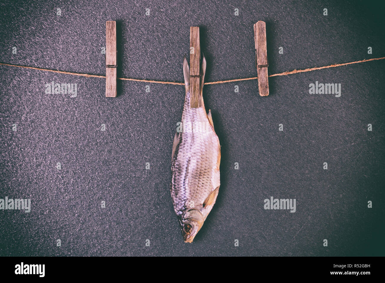 Dried fish hanging on the rope Stock Photo - Alamy