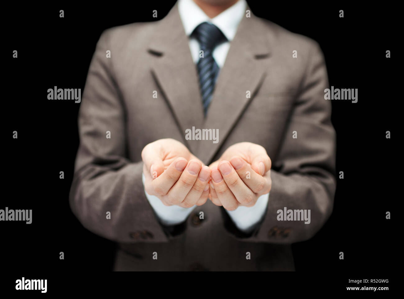 Man on black background with open hands. Holding, giving, showing ...