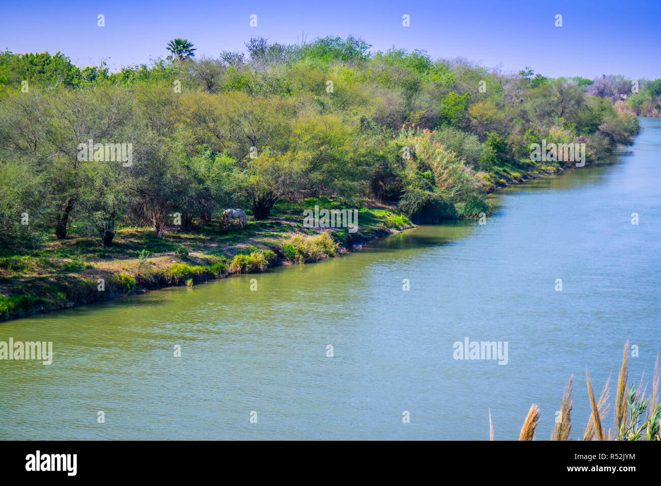 A large flow of water river connecting the Mexico-United States border ...