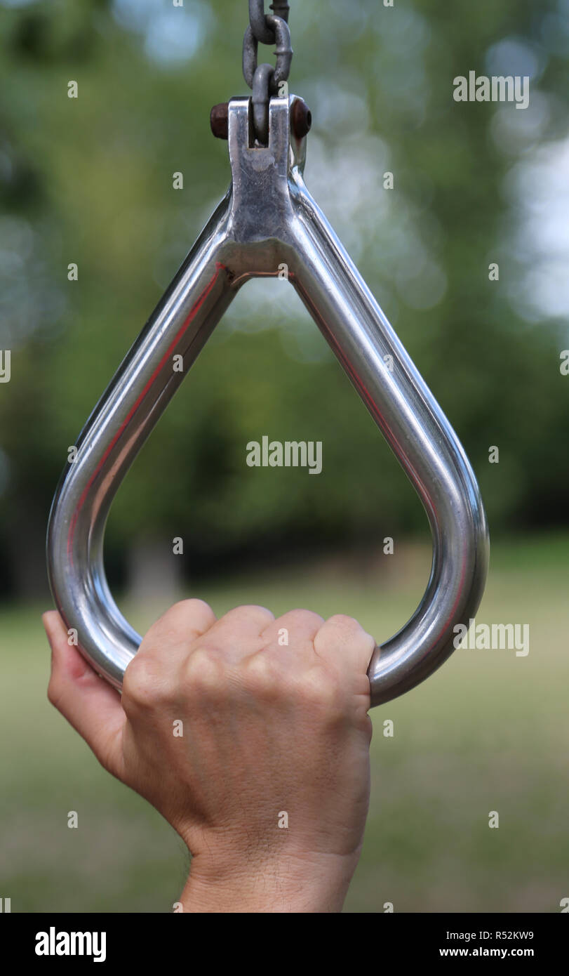 athlete's hand during workouts with steel ring in an outdoor gym Stock ...