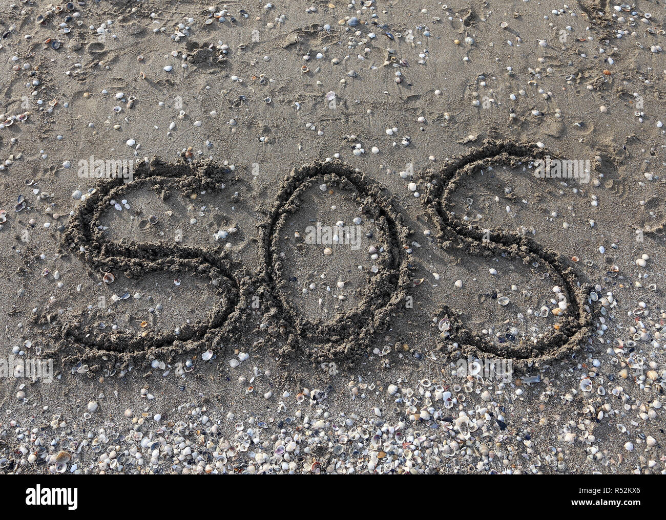 big text SOS on the beach sand Stock Photo - Alamy